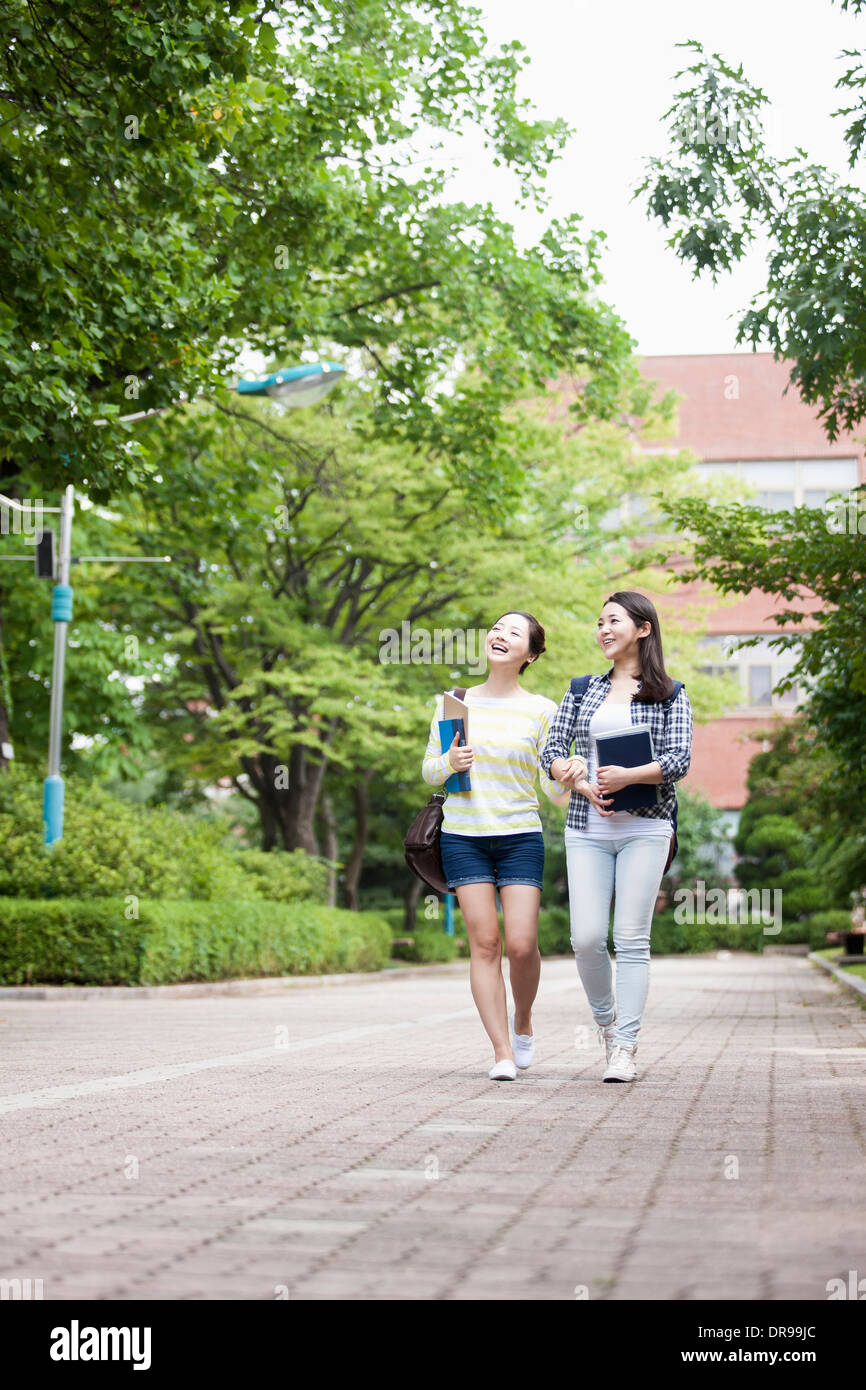 university students walking in the campus talking Stock Photo - Alamy