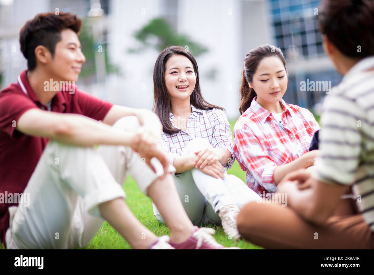 students sitting on grass having a conversation Stock Photo - Alamy