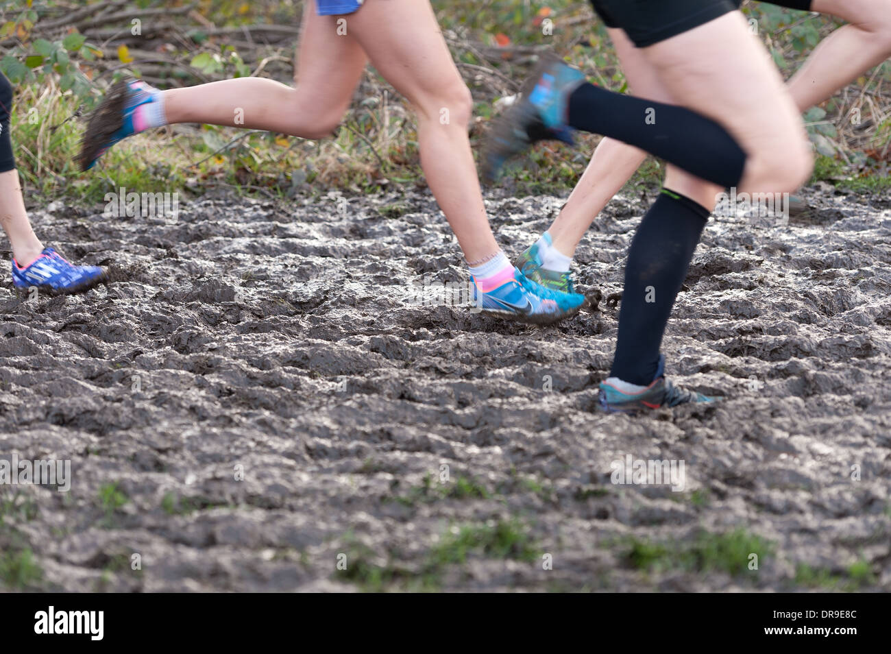 Squelchy slippery muddy footpath with lots of runners striding through ...