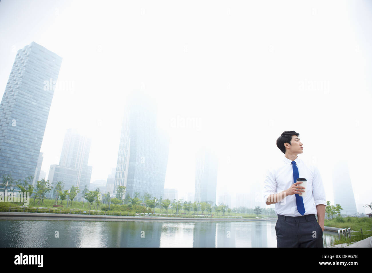 Asian businessman standing next hi-res stock photography and images - Alamy