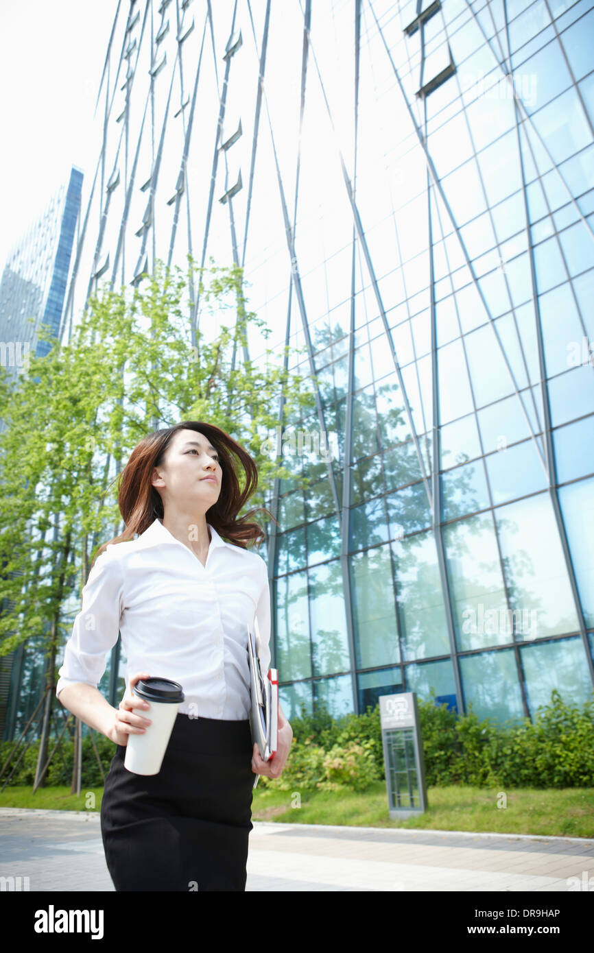 a business woman running with a coffee Stock Photo - Alamy
