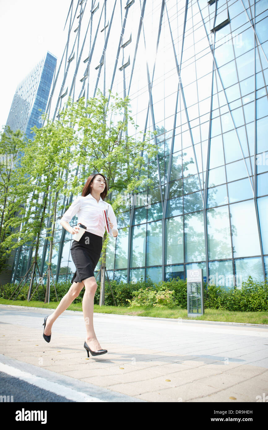 a business woman running with a coffee Stock Photo - Alamy