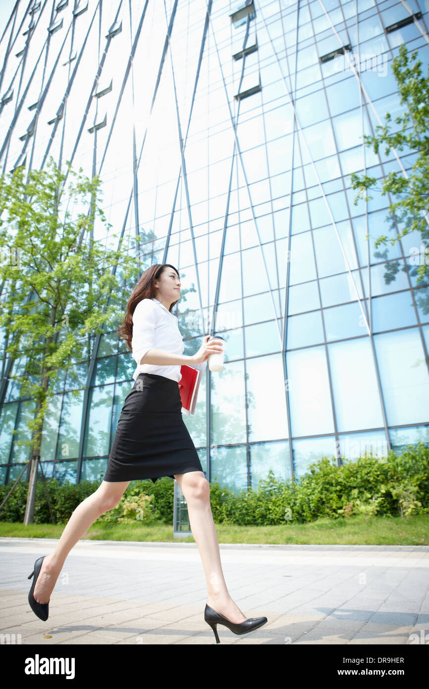 a business woman running with a coffee Stock Photo - Alamy