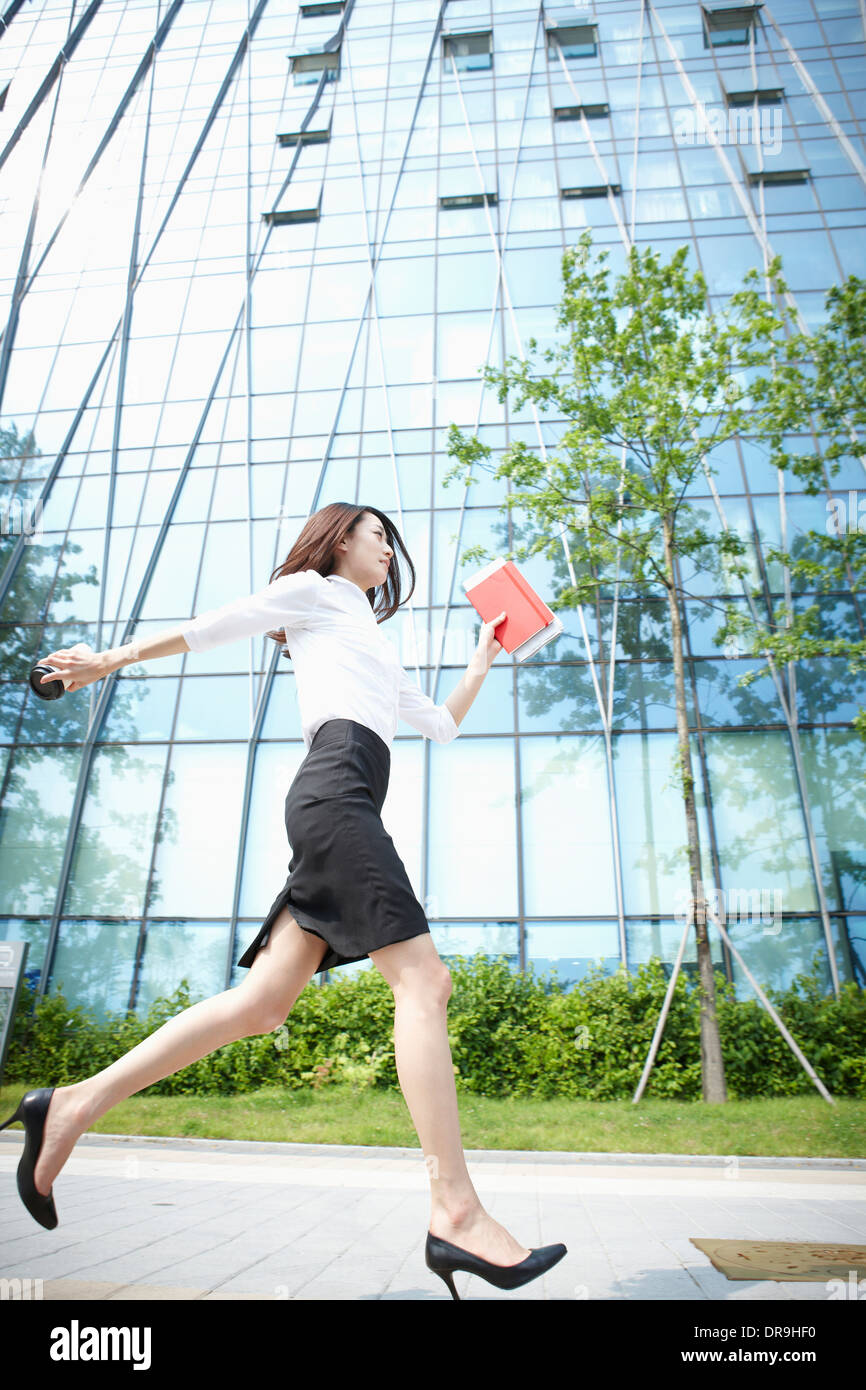 a business woman running with a coffee Stock Photo - Alamy