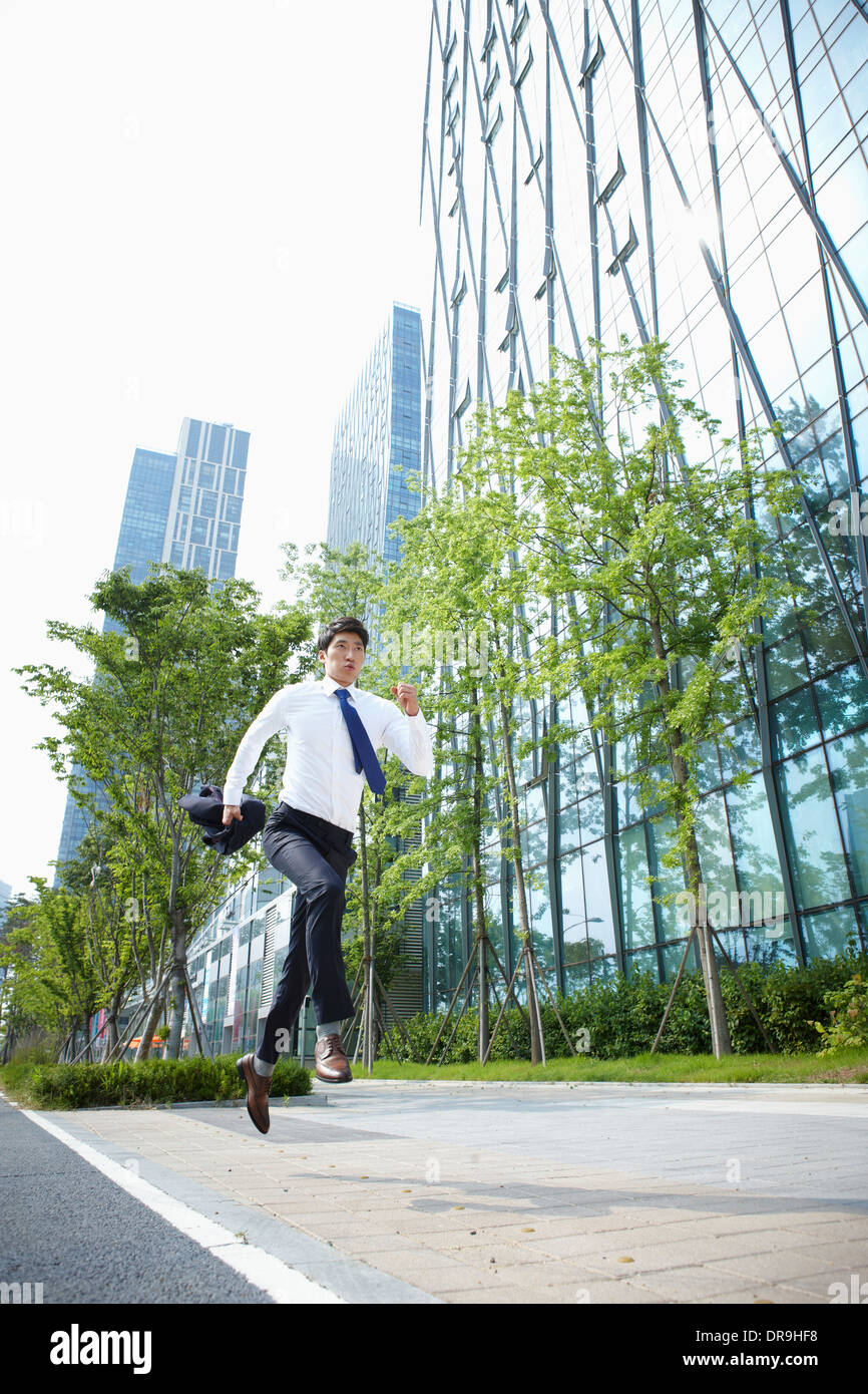 a business man running on the street Stock Photo - Alamy