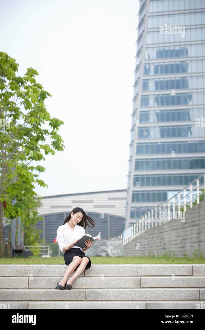 a business woman sitting outside and working Stock Photo - Alamy