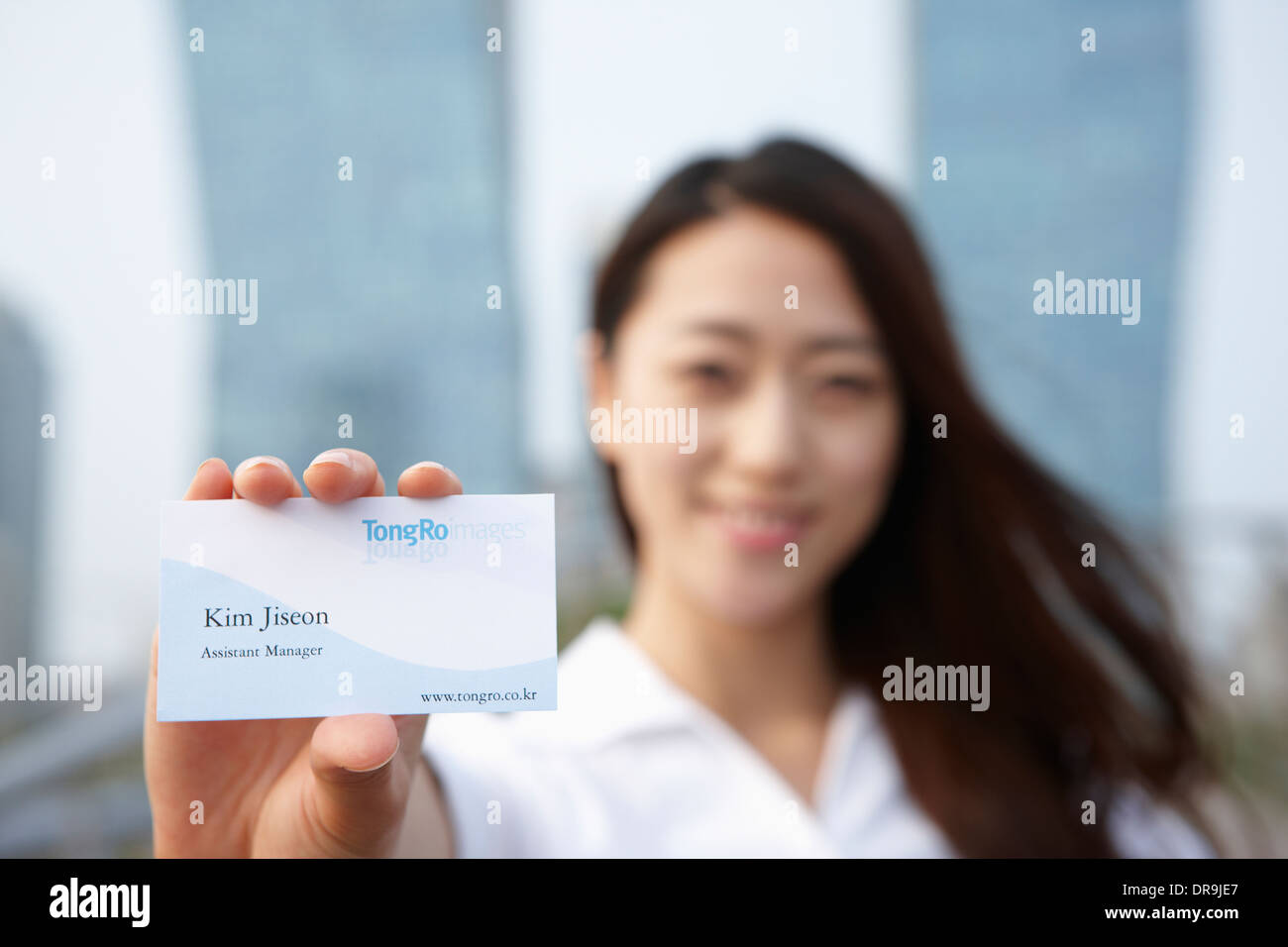 a business woman showing business card Stock Photo - Alamy