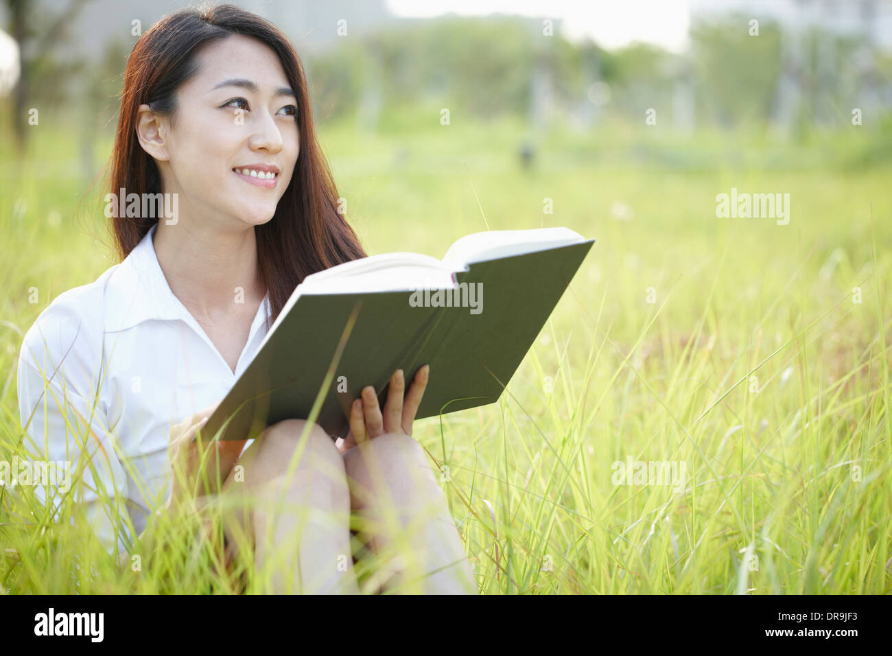 Nature woman field reading hi-res stock photography and images - Alamy