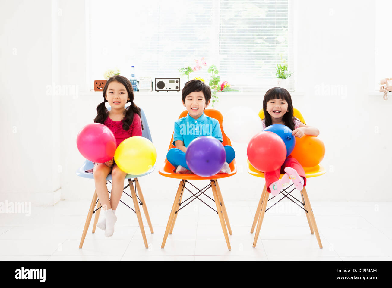 kids sitting on chairs Stock Photo - Alamy