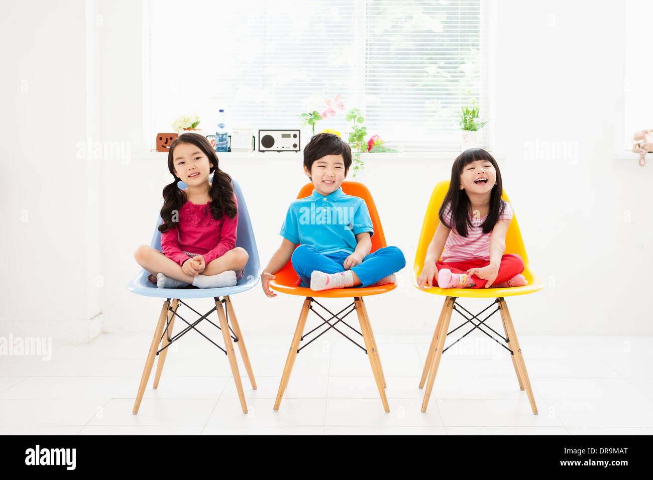kids sitting on chairs Stock Photo - Alamy