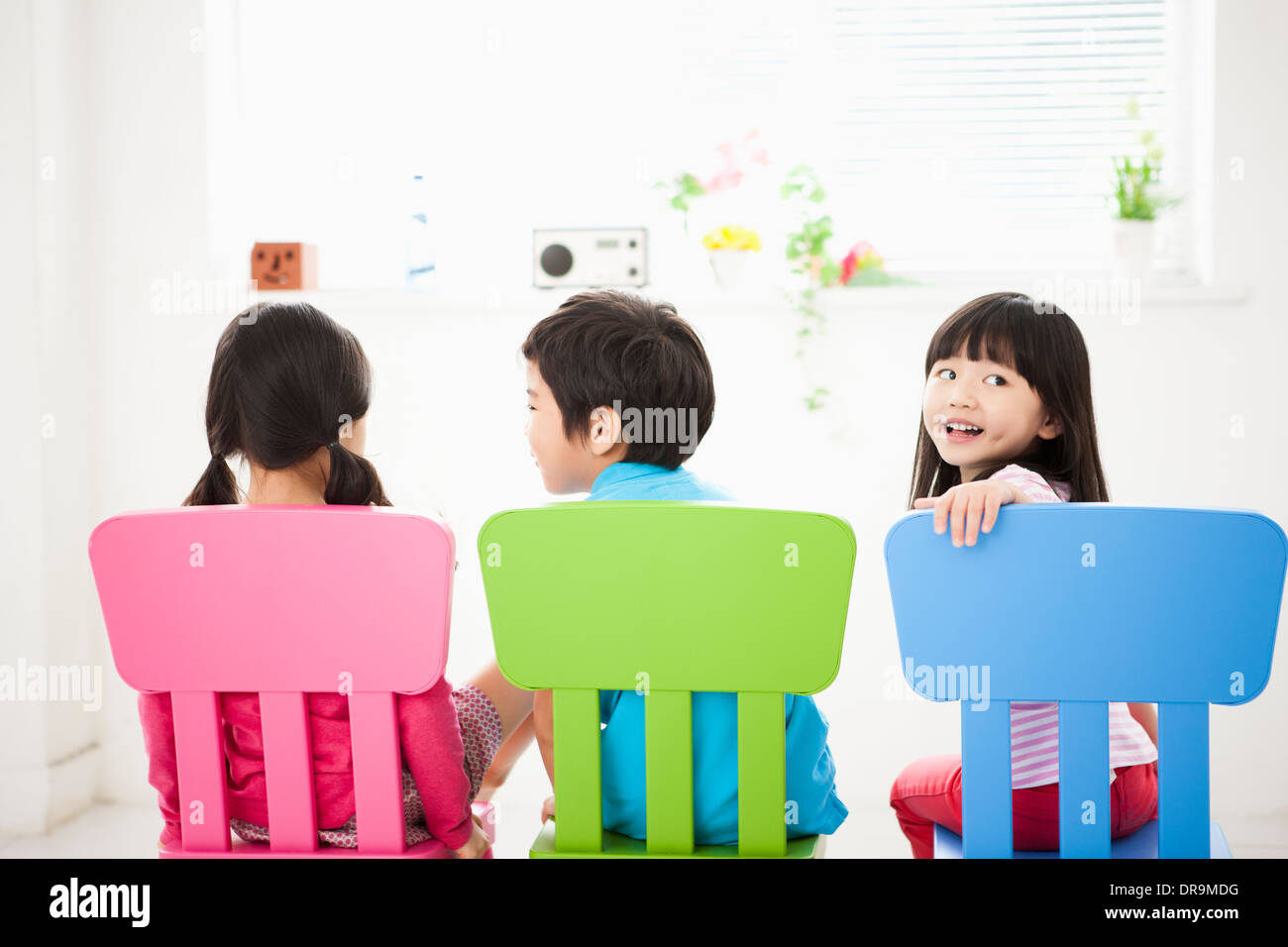 kids sitting on chairs Stock Photo - Alamy