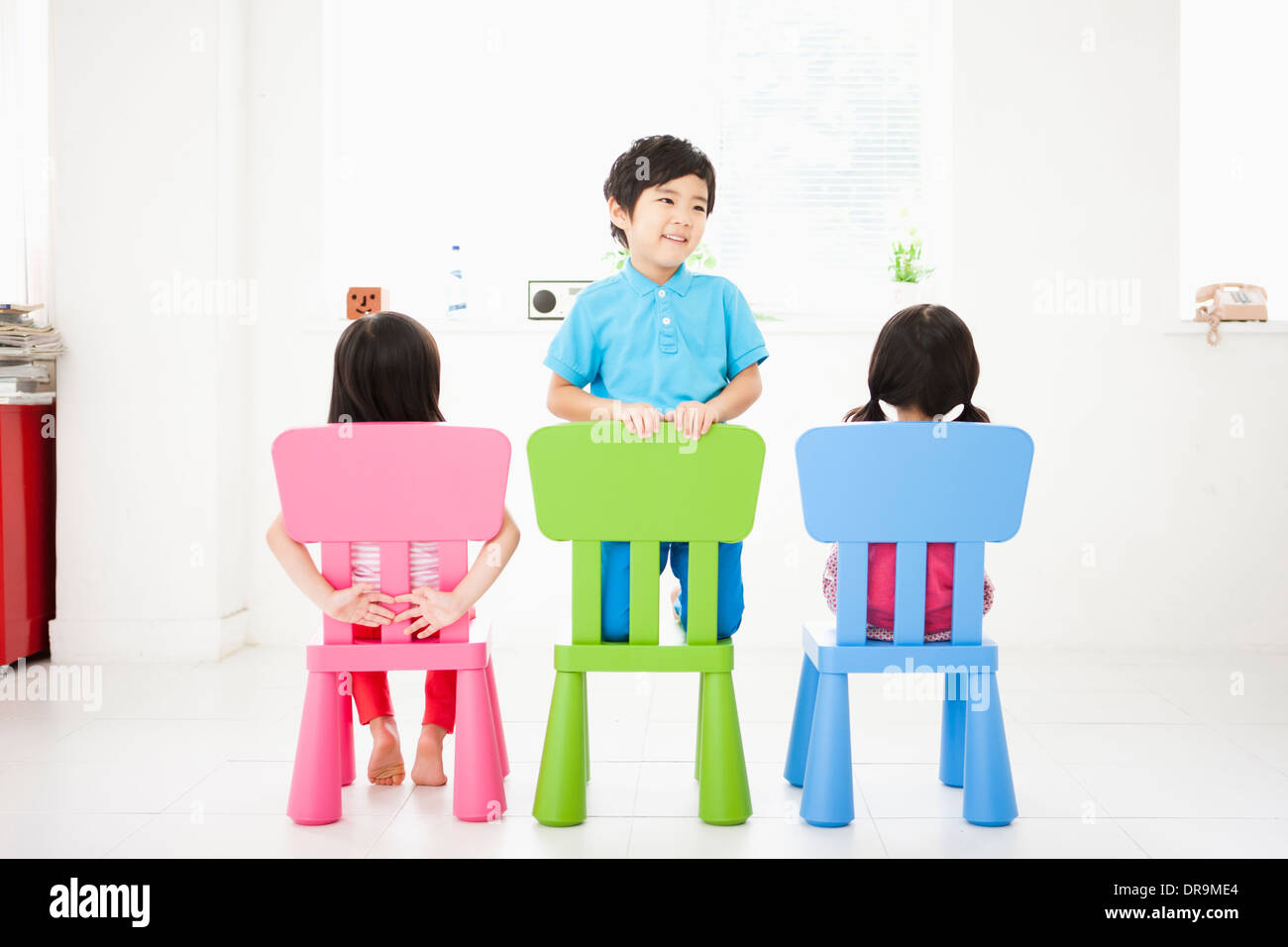 kids sitting on chairs Stock Photo - Alamy