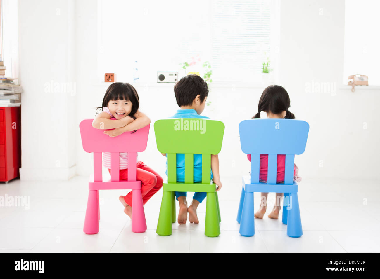 kids sitting on chairs Stock Photo - Alamy
