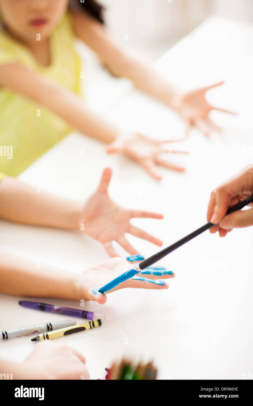 kids playing with finger colors Stock Photo - Alamy