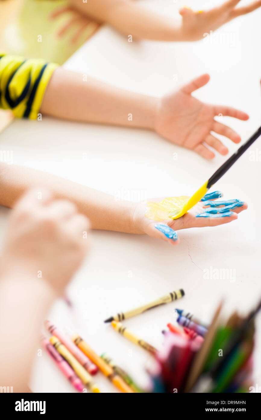 kids playing with finger colors Stock Photo - Alamy