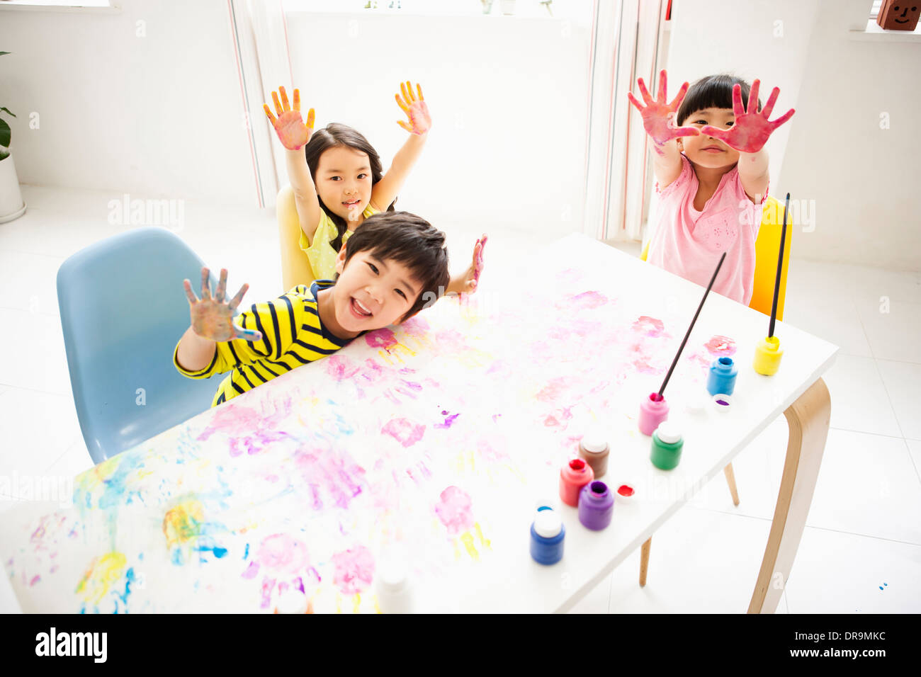 kids playing with finger colors Stock Photo - Alamy