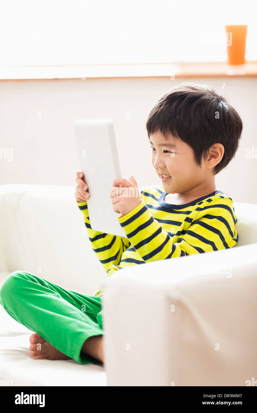 a boy playing with a tablet Stock Photo - Alamy