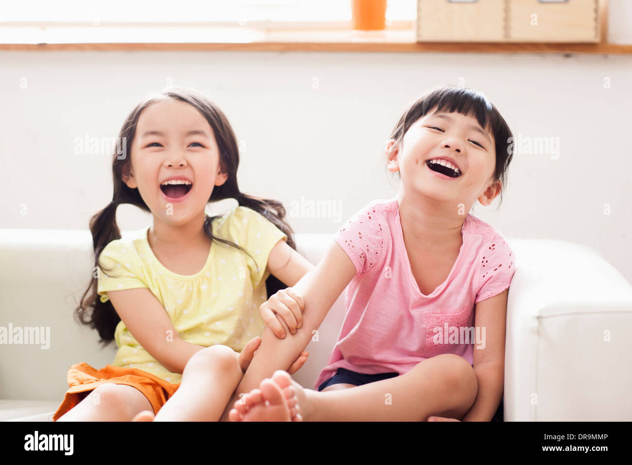 kids sitting on couch Stock Photo - Alamy