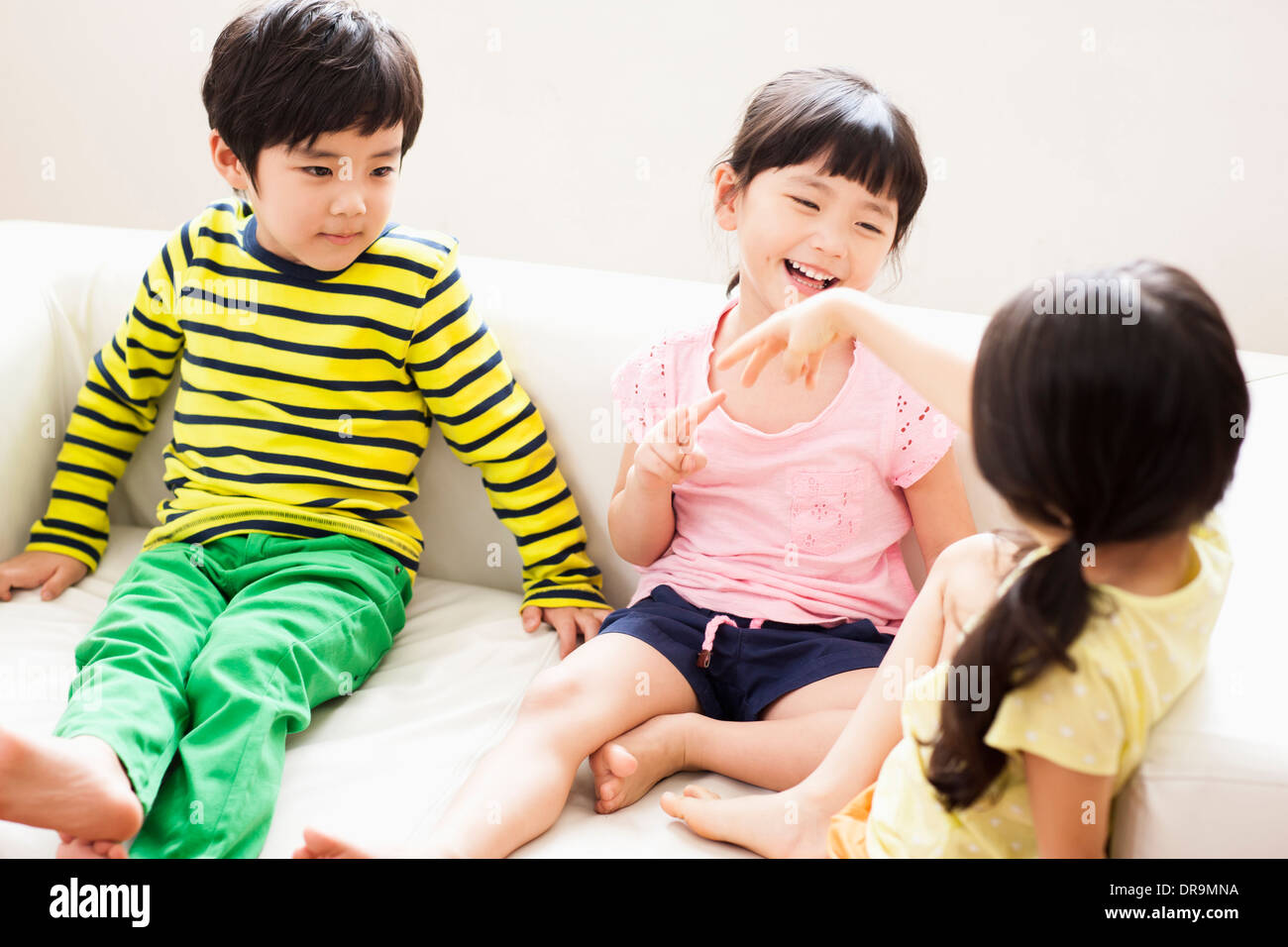 kids sitting on couch Stock Photo - Alamy