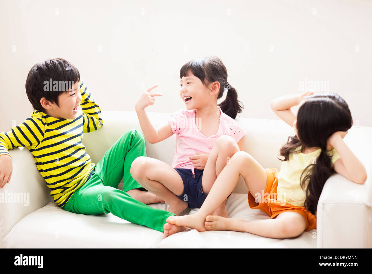 kids sitting on couch Stock Photo - Alamy