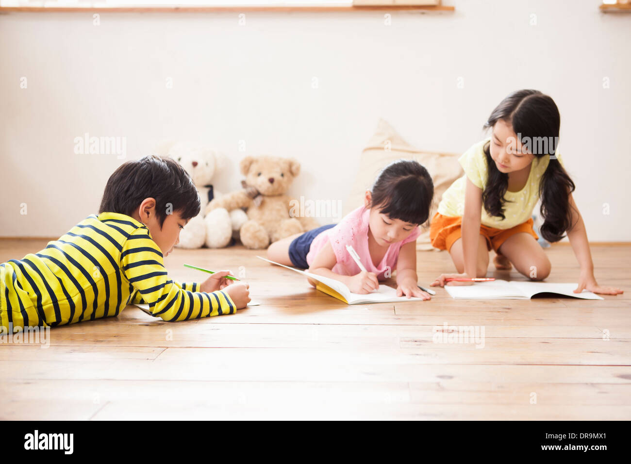 kids writing into a book Stock Photo - Alamy
