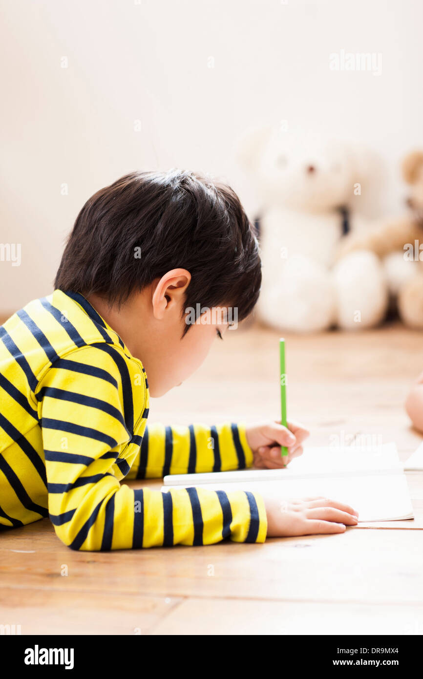 kids writing into a book Stock Photo - Alamy