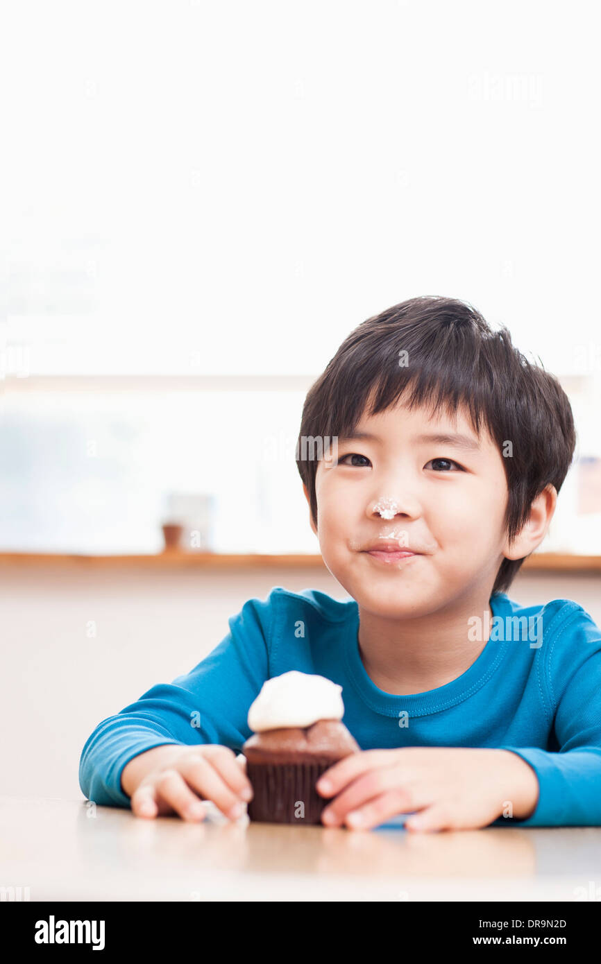 Boy eating a cupcake hi-res stock photography and images - Alamy