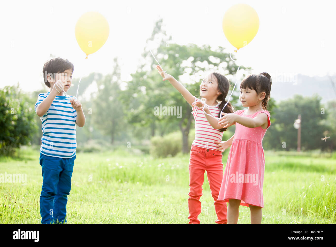 Kids playing balloons on field hi-res stock photography and images - Alamy