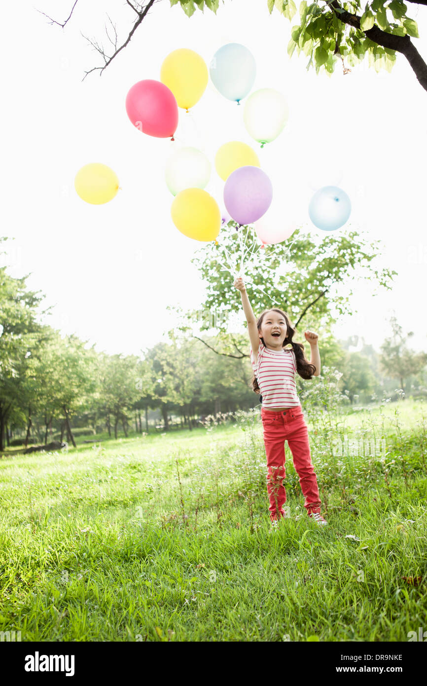 a girl playing with balloons Stock Photo - Alamy