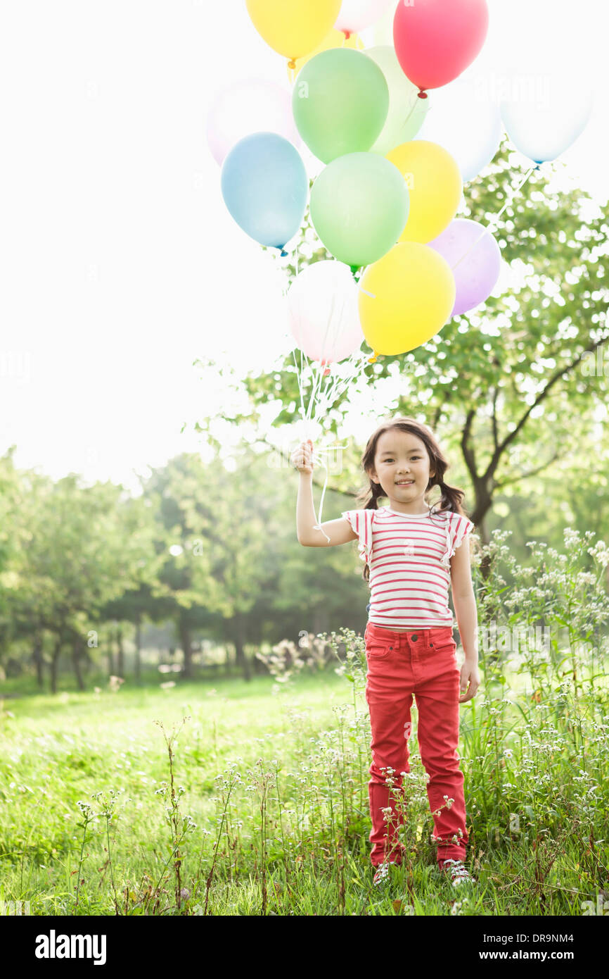 a girl playing with balloons Stock Photo - Alamy