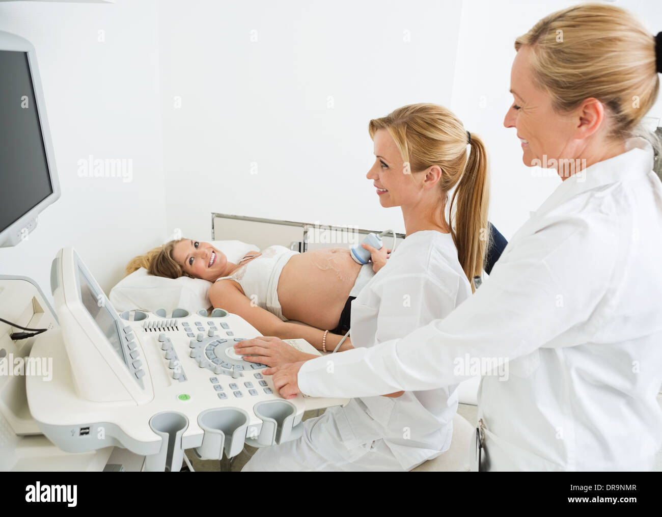 Gynecologists Examining Pregnant Belly By Ultrasonic Scan Stock Photo ...