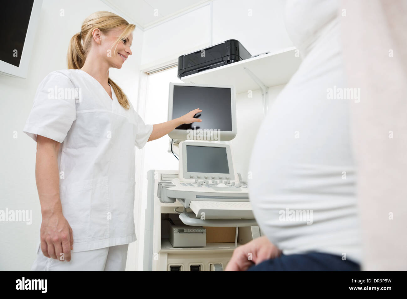 Gynecologist Showing Ultrasound Scan To Pregnant Woman Stock Photo - Alamy