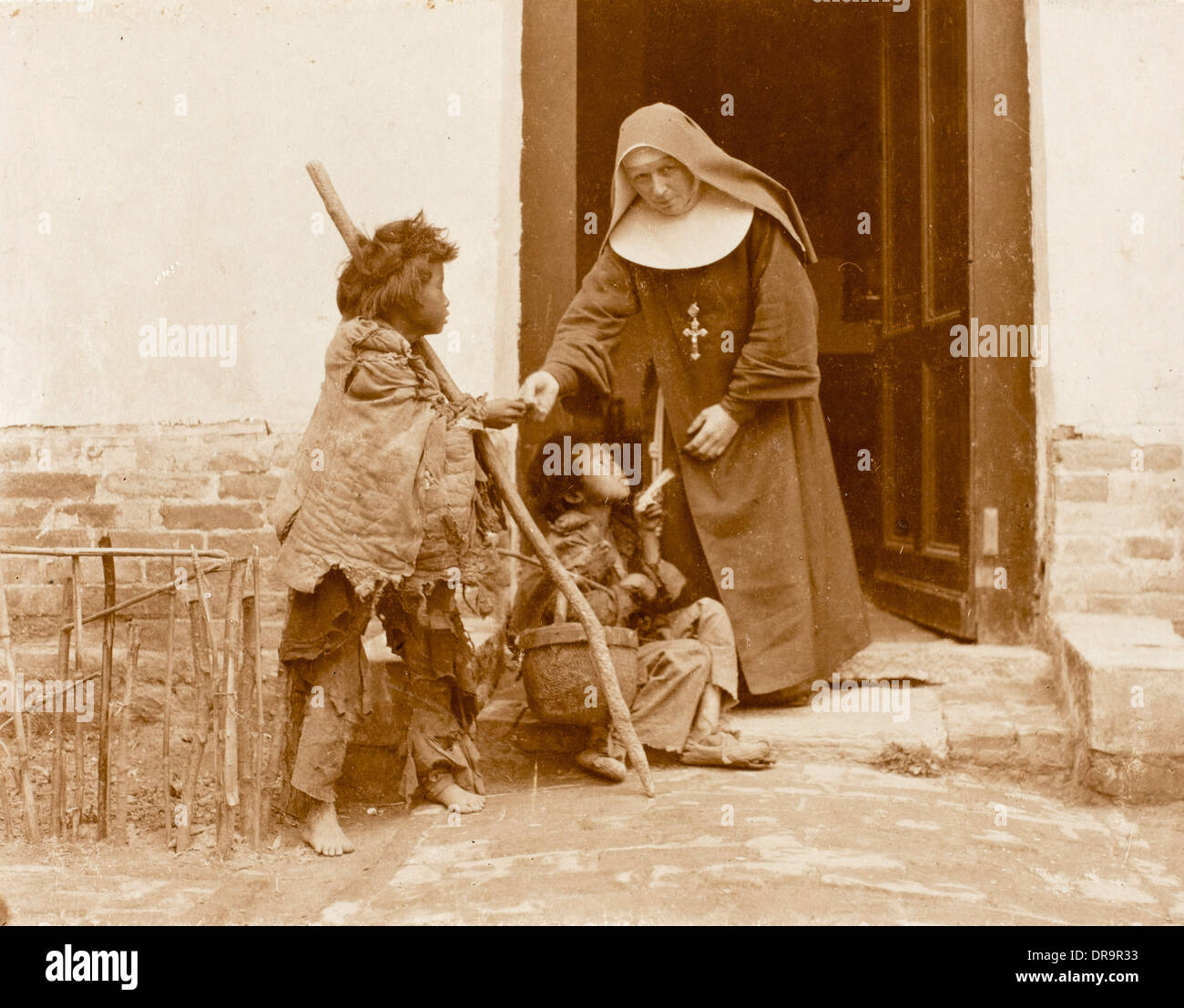 Shanghai - Nun giving alms to young beggar children Stock Photo - Alamy
