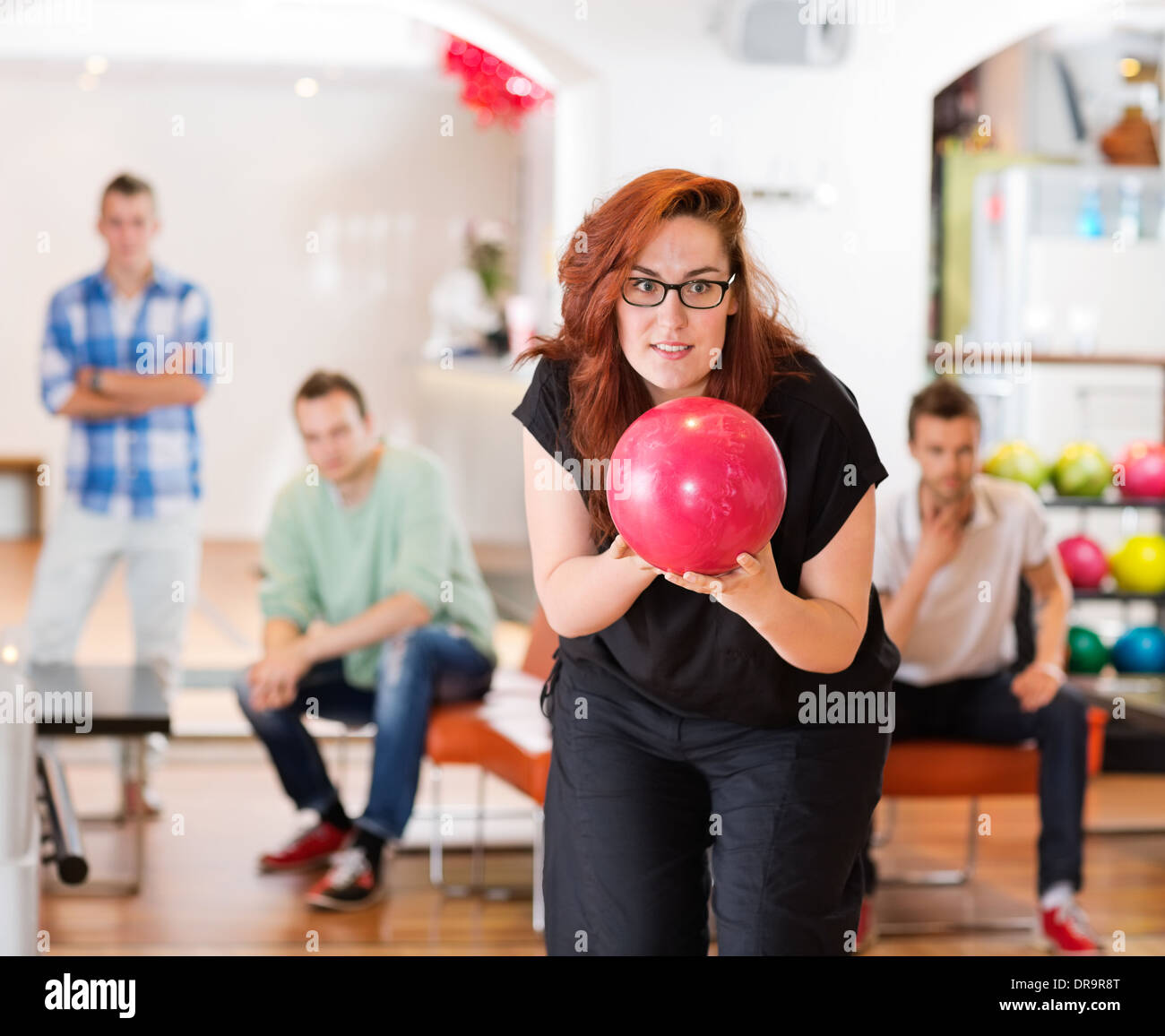 Woman Ready With Bowling Ball in Club Stock Photo - Alamy