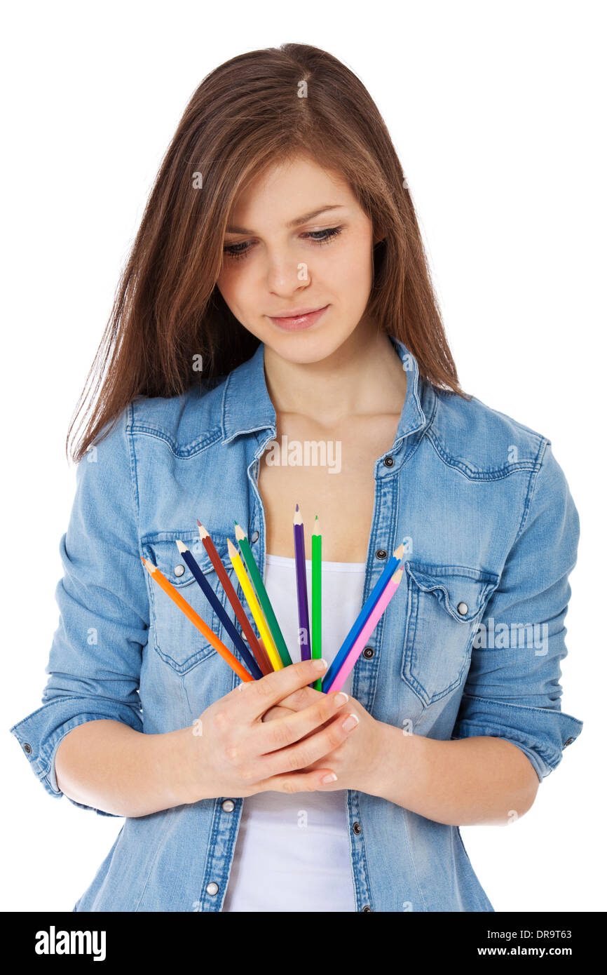 Attractive teenage girl holding colorful crayons. All on white ...