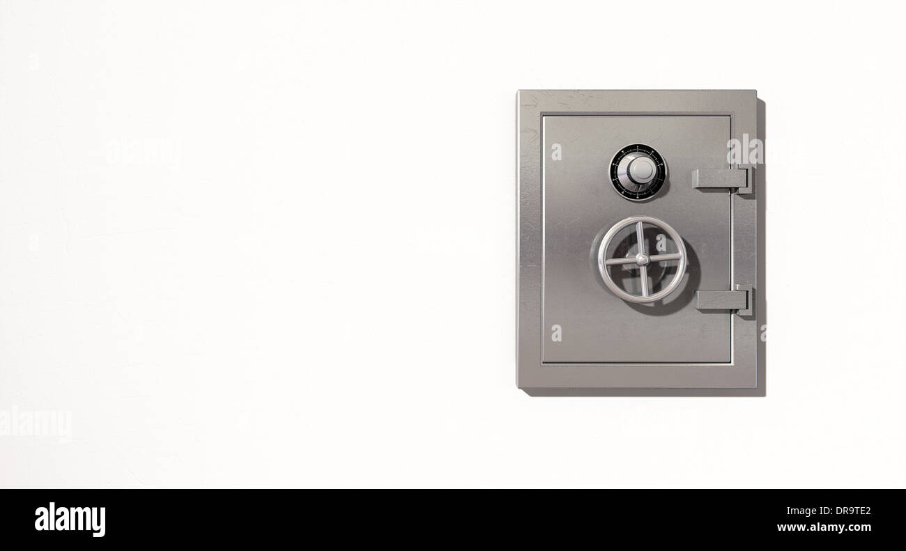 A closed metal safe on a light colored isolated wall background Stock ...