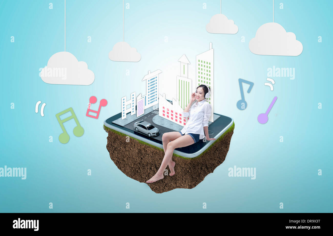a kid sitting on a floating land listening to music Stock Photo - Alamy