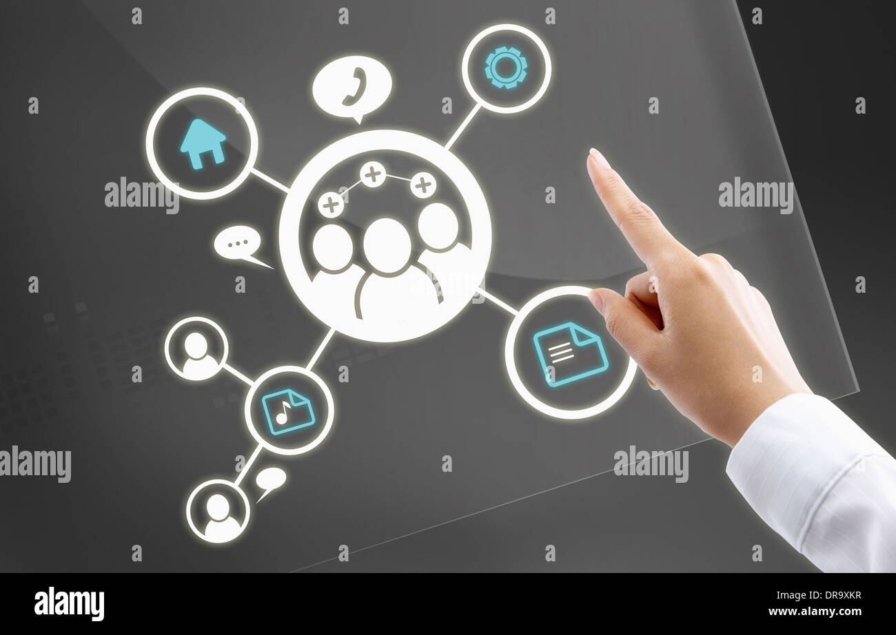 a hand pointing at icons in the screen Stock Photo - Alamy