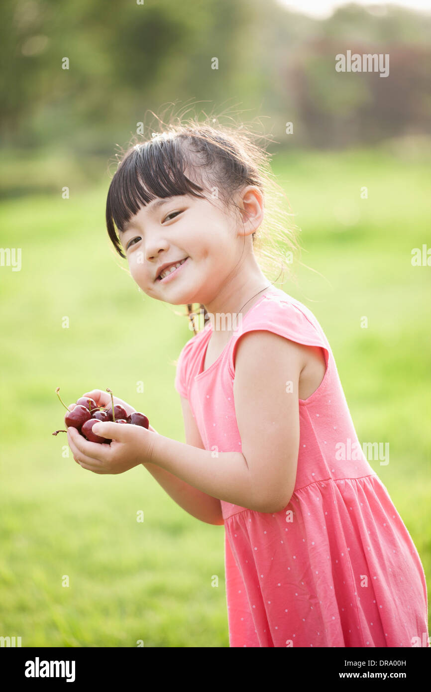 Woman smiling holding cherry hi-res stock photography and images - Alamy