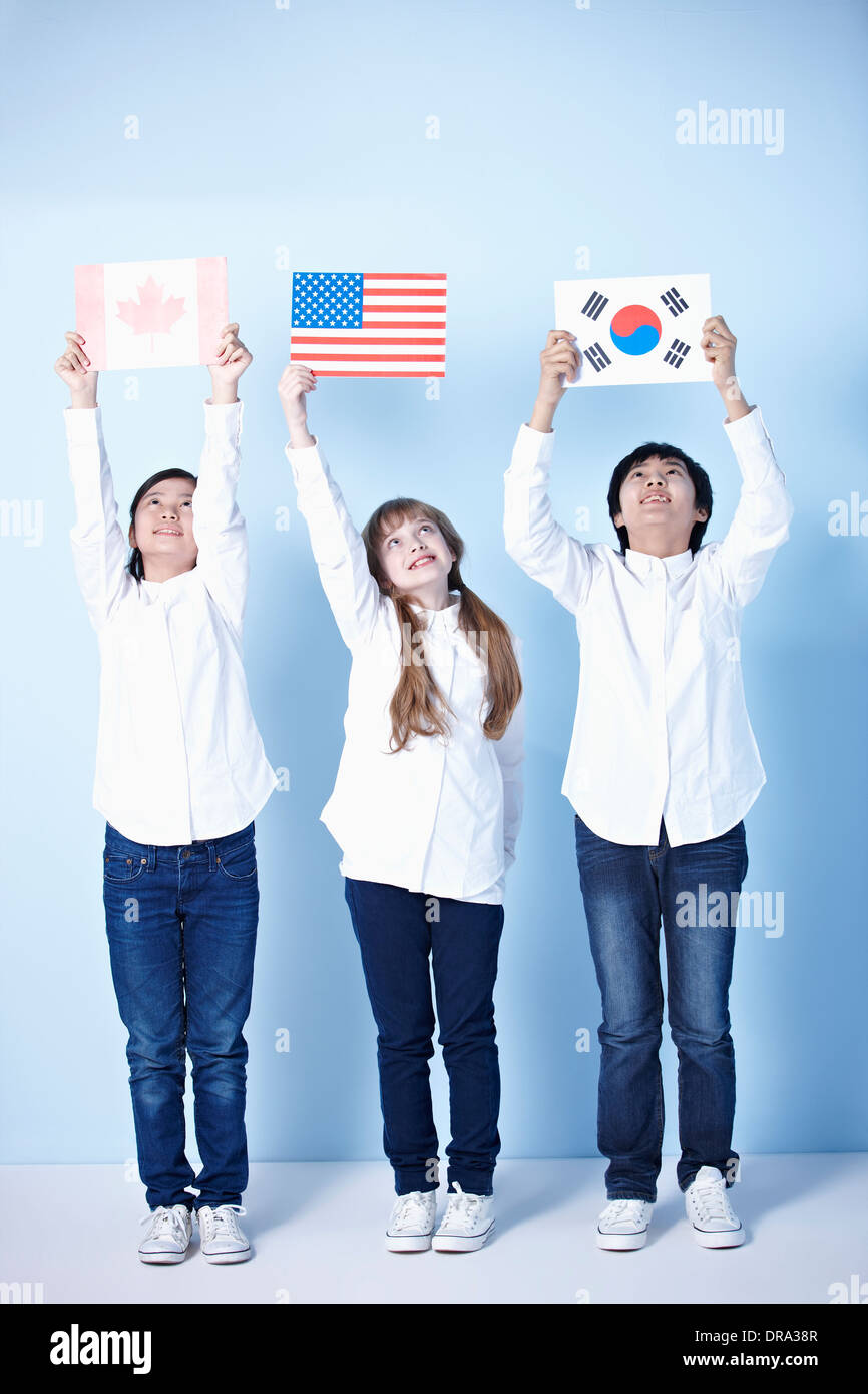 three kids holding different flags Stock Photo - Alamy