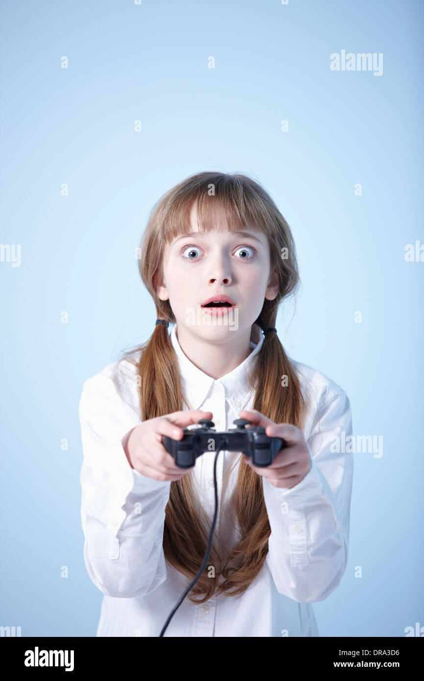 Girl playing handheld video game hi-res stock photography and images ...
