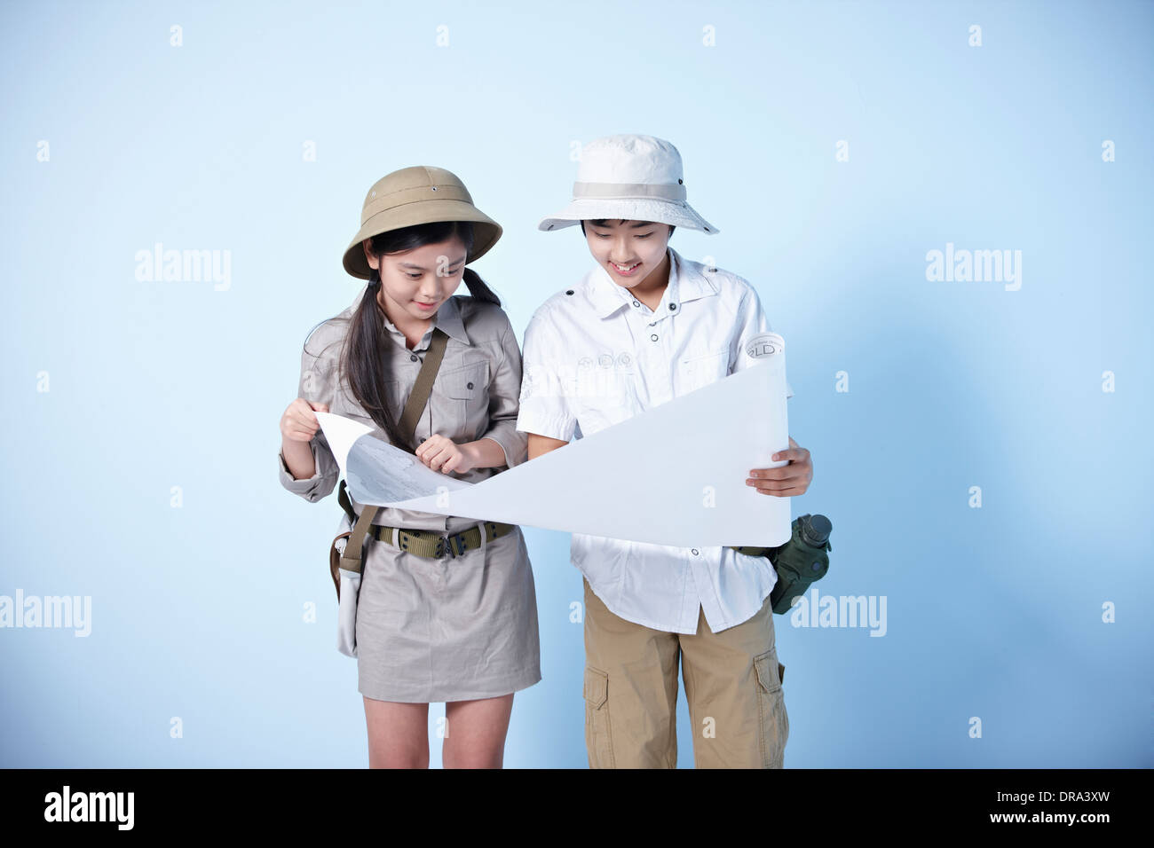 kids dressed as explorers while looking at a map Stock Photo - Alamy