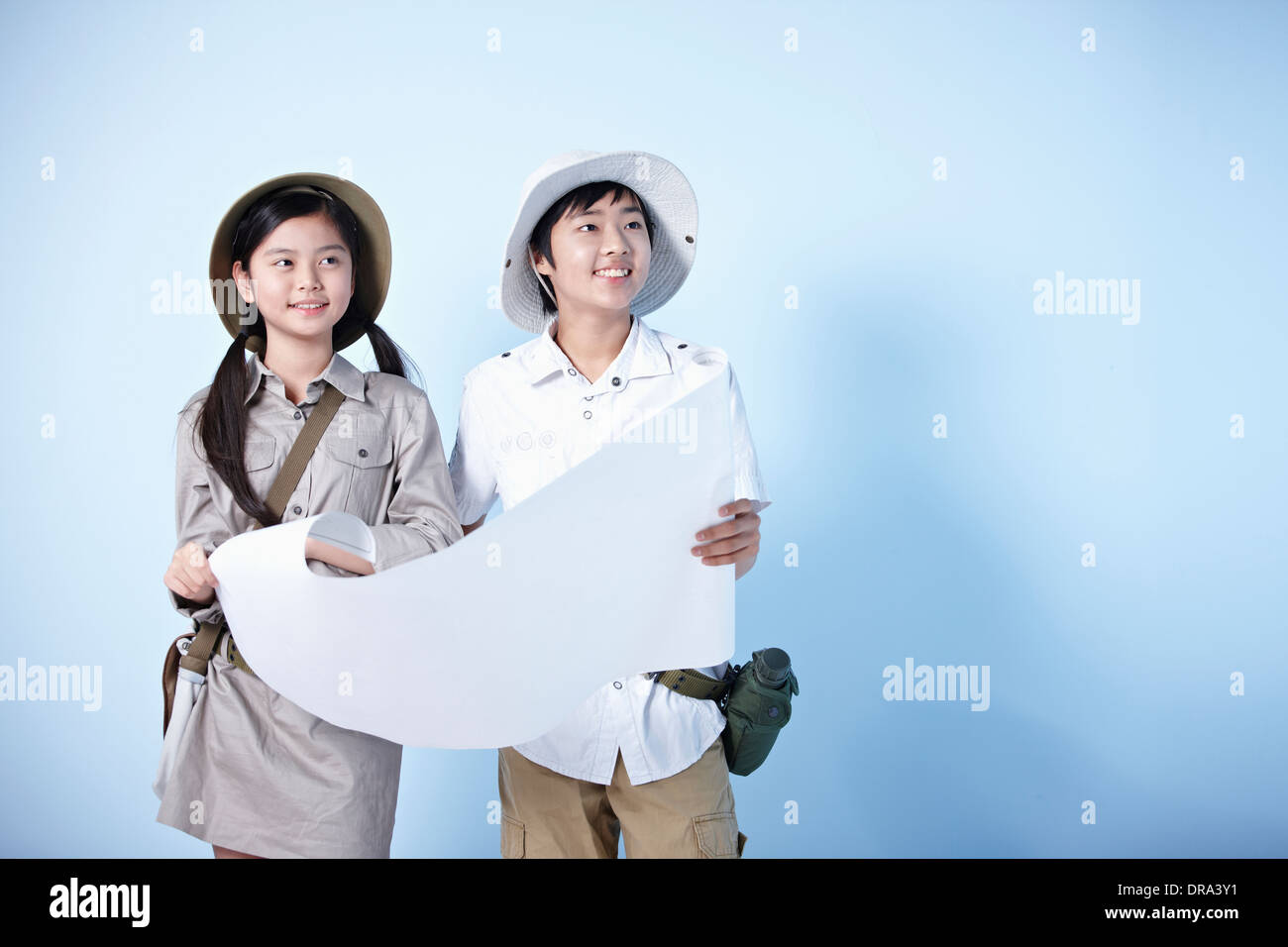 kids dressed as explorers while looking at a map Stock Photo - Alamy