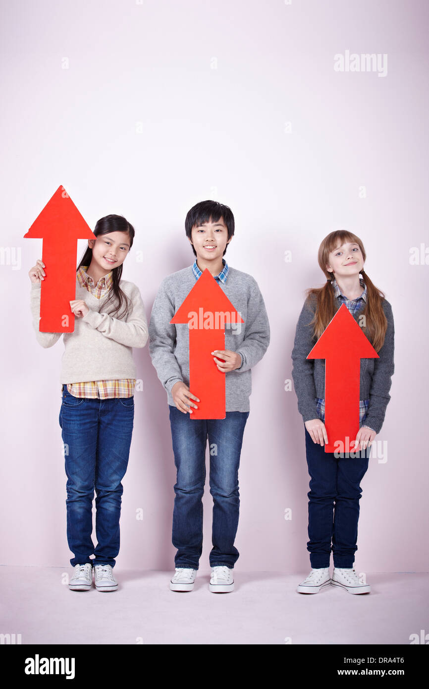 kids standing and holding red arrows Stock Photo - Alamy