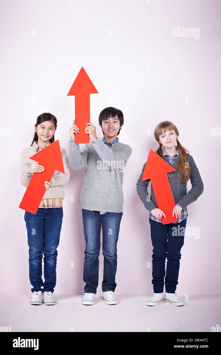 kids standing and holding red arrows Stock Photo - Alamy