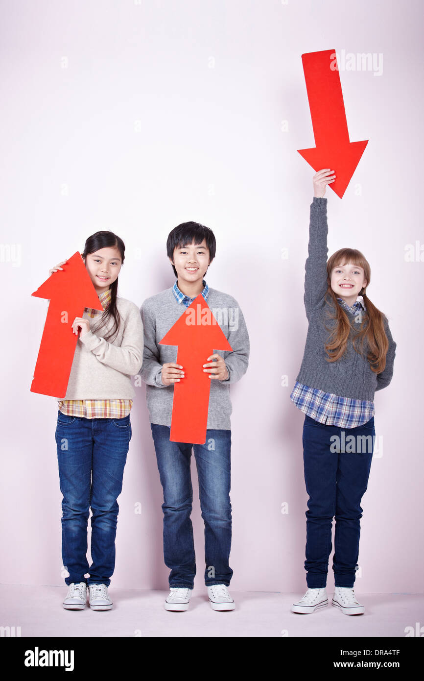 kids standing and holding red arrows Stock Photo - Alamy