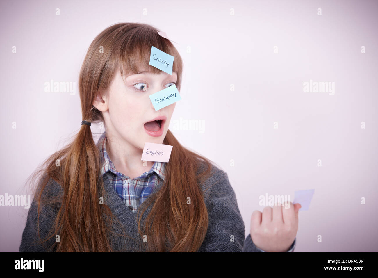 a girl with post-it notes all over her head Stock Photo - Alamy