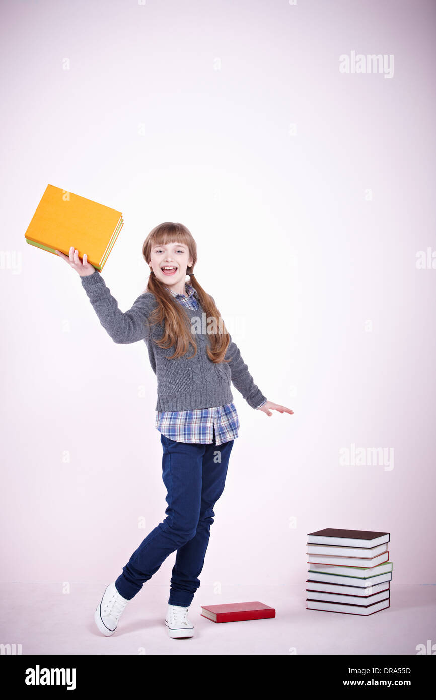 Girl showing pile books hi-res stock photography and images - Alamy