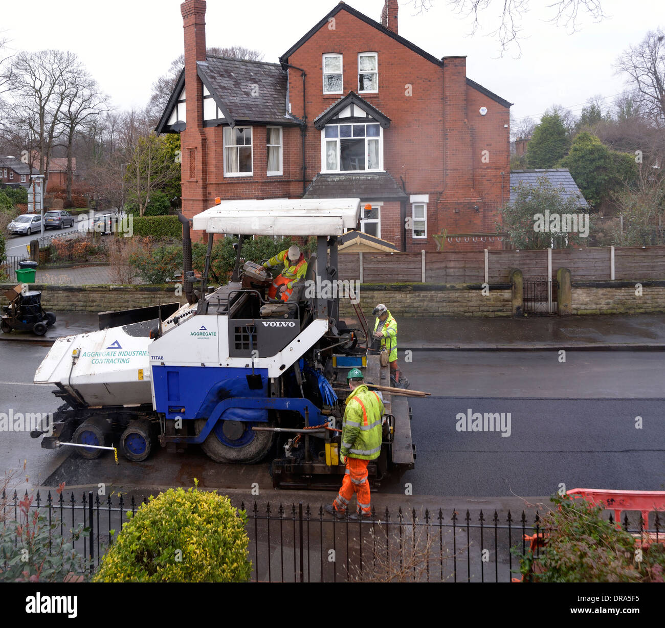 workmen resurface a street with new tarmac Stock Photo - Alamy