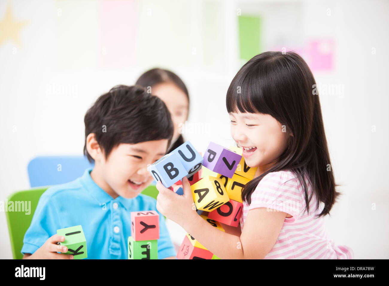 Boy girl child table playing laughing hi-res stock photography and images - Alamy